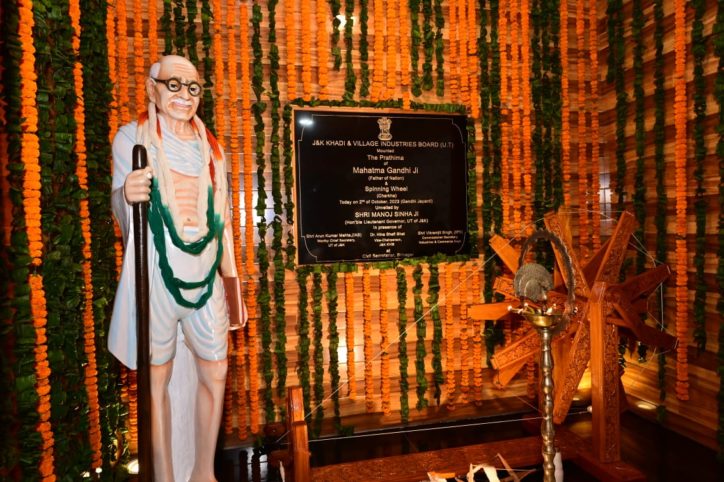A statue of Pujya Mahatma Gandhi with a Charkha installed thereupon ...